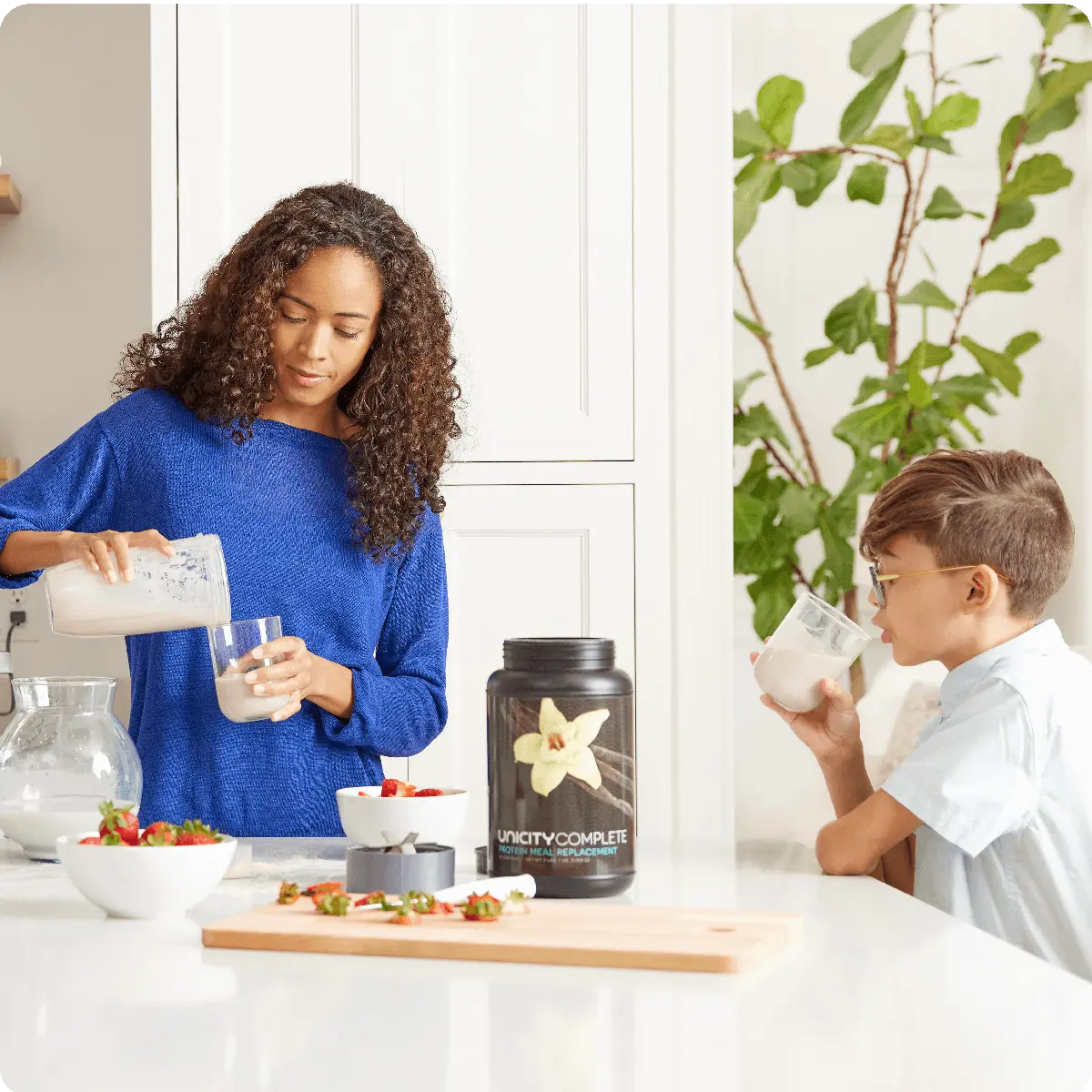 Woman Making Shake With Unicity s Complete Meal Replacement Powder