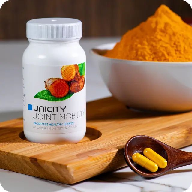 Bottle of Joint Mobility next to powder and capsules