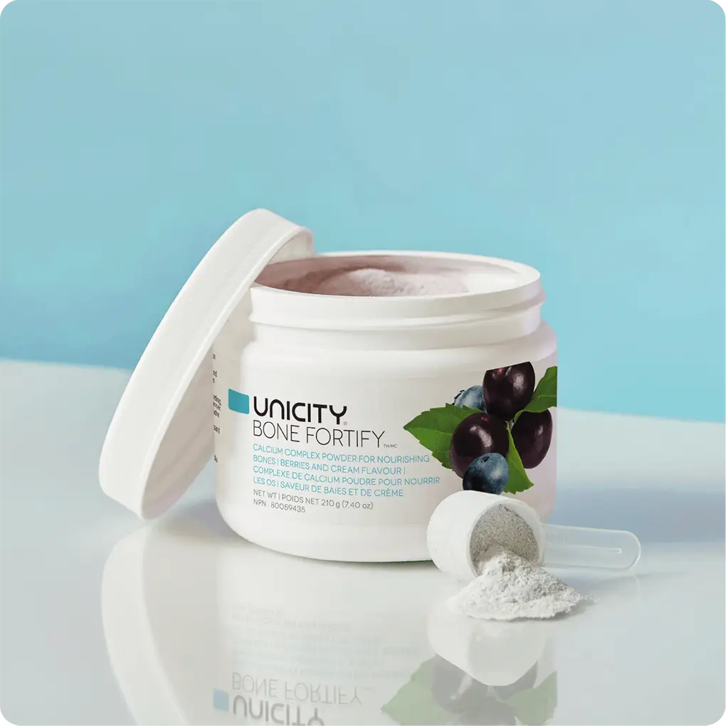 Scoop next to canister of Bone Fortify with open lid