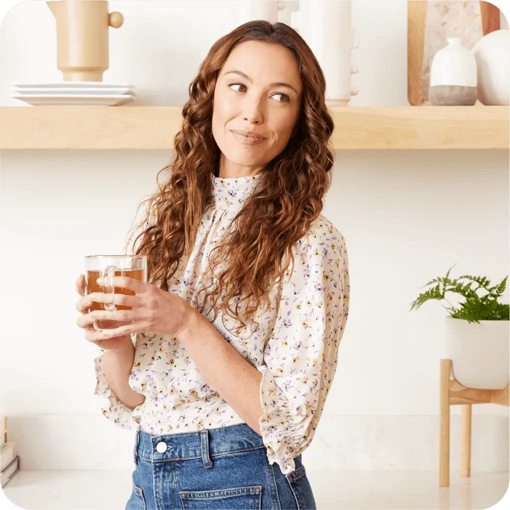 Woman holding glass of Unimate