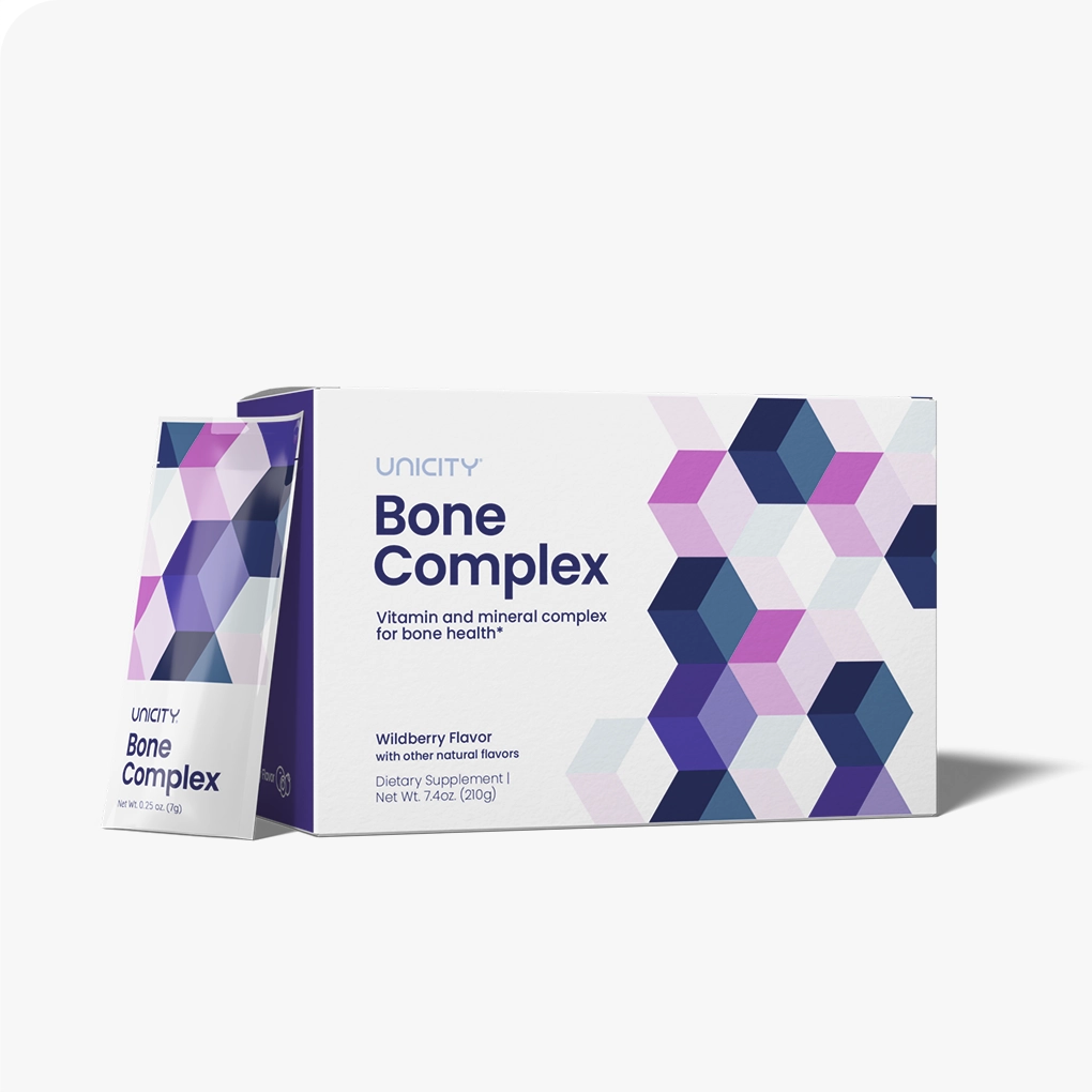 Caja y sobre del suplemento Unicity Bone Complex con calcio, vitamina D y magnesio para ...